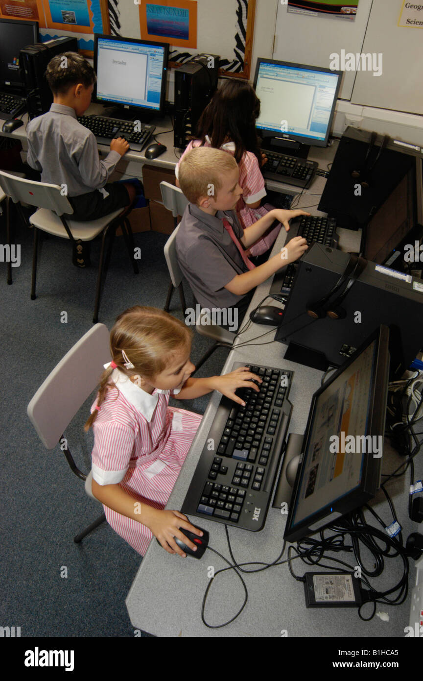 children in school learning on computers Stock Photo - Alamy