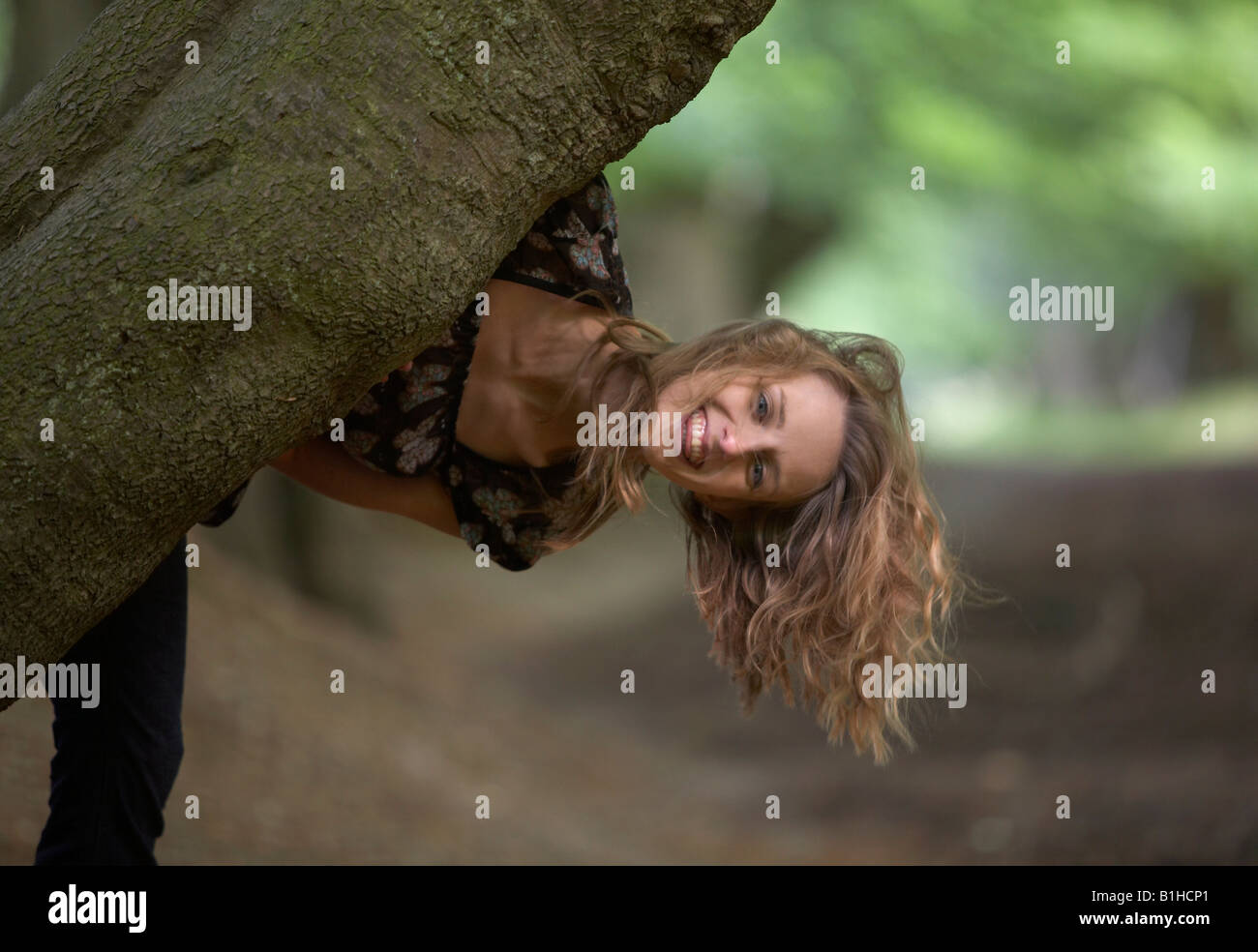Young woman hiding behind tree Stock Photo - Alamy Young woman hiding behind tree Stock Photo - Alamy