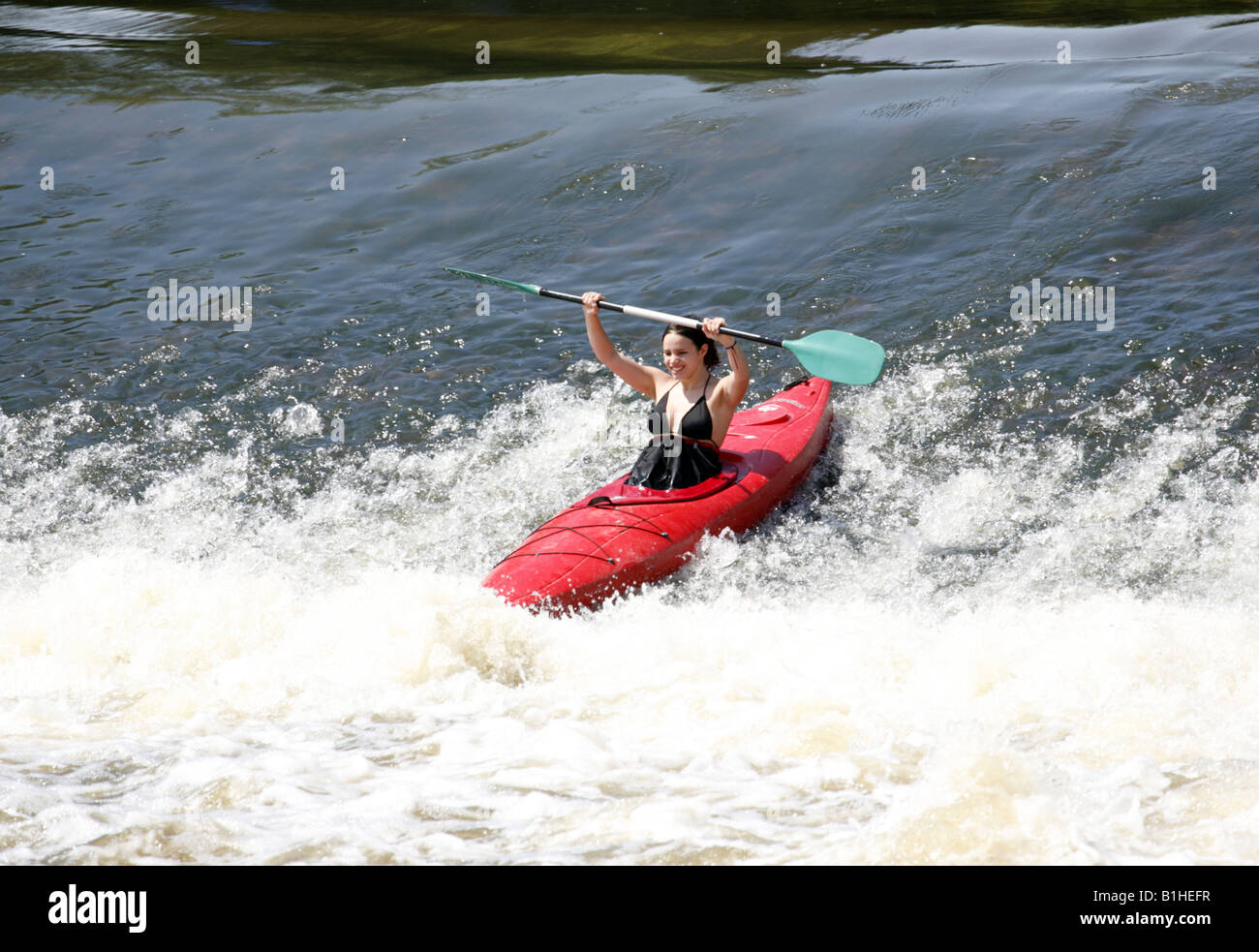 Young Woman in Kayak Shooting a Weir Stock Photo - Alamy