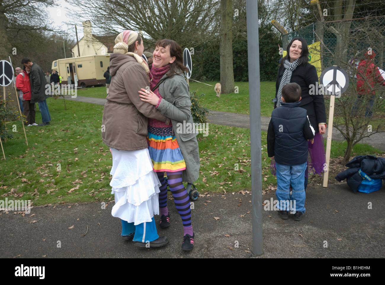Women hug in greeting outside gate of Aldermaston nuclear bomb factory ...