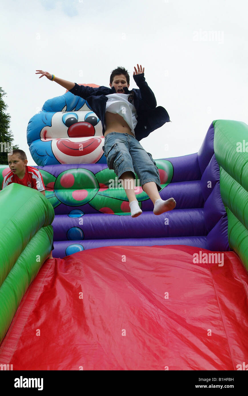 Young boy jumping on inflatable slide at a children's party Stock Photo ...