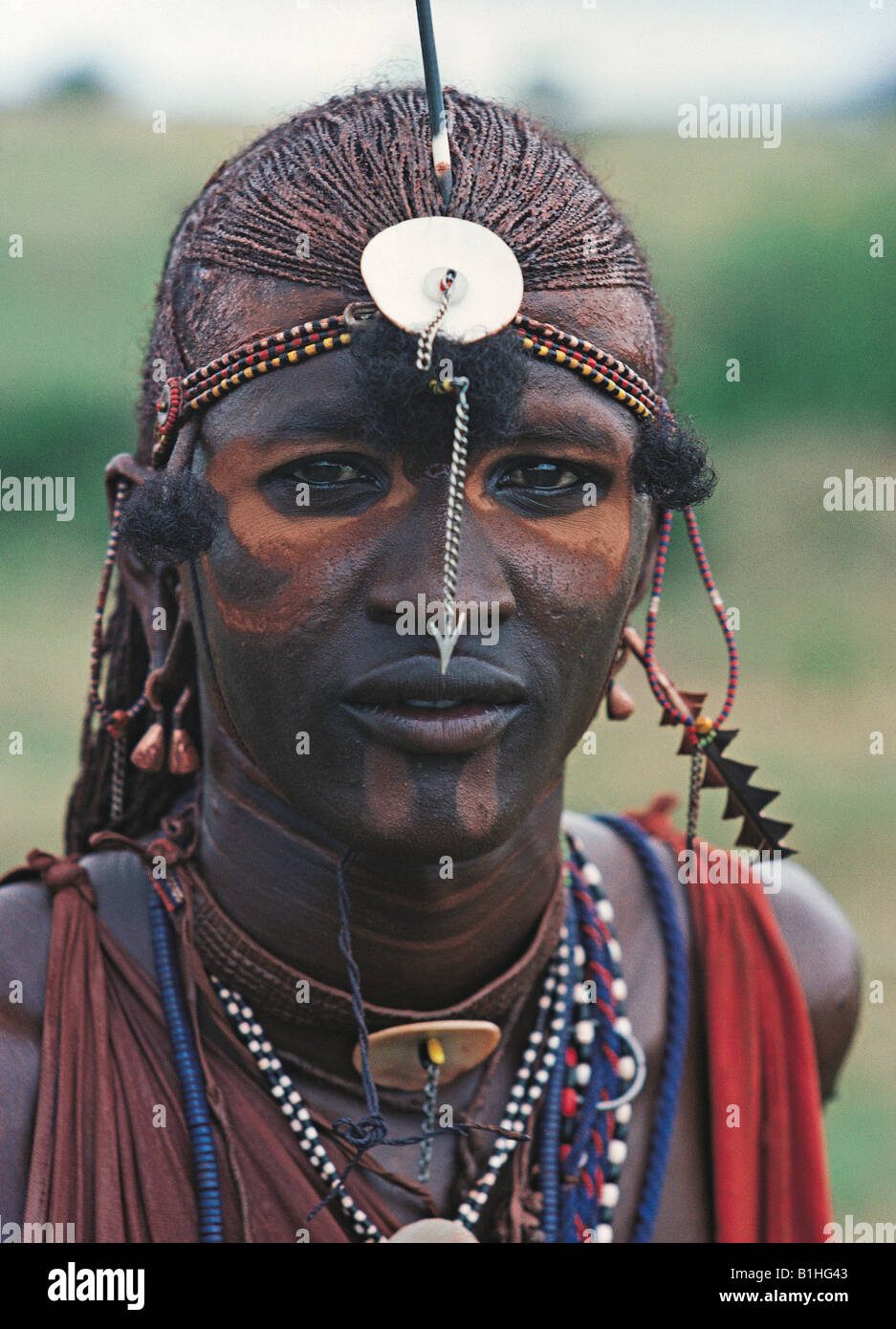 Portrait of Maasai moran or warrior wearing red ochre make up and ...