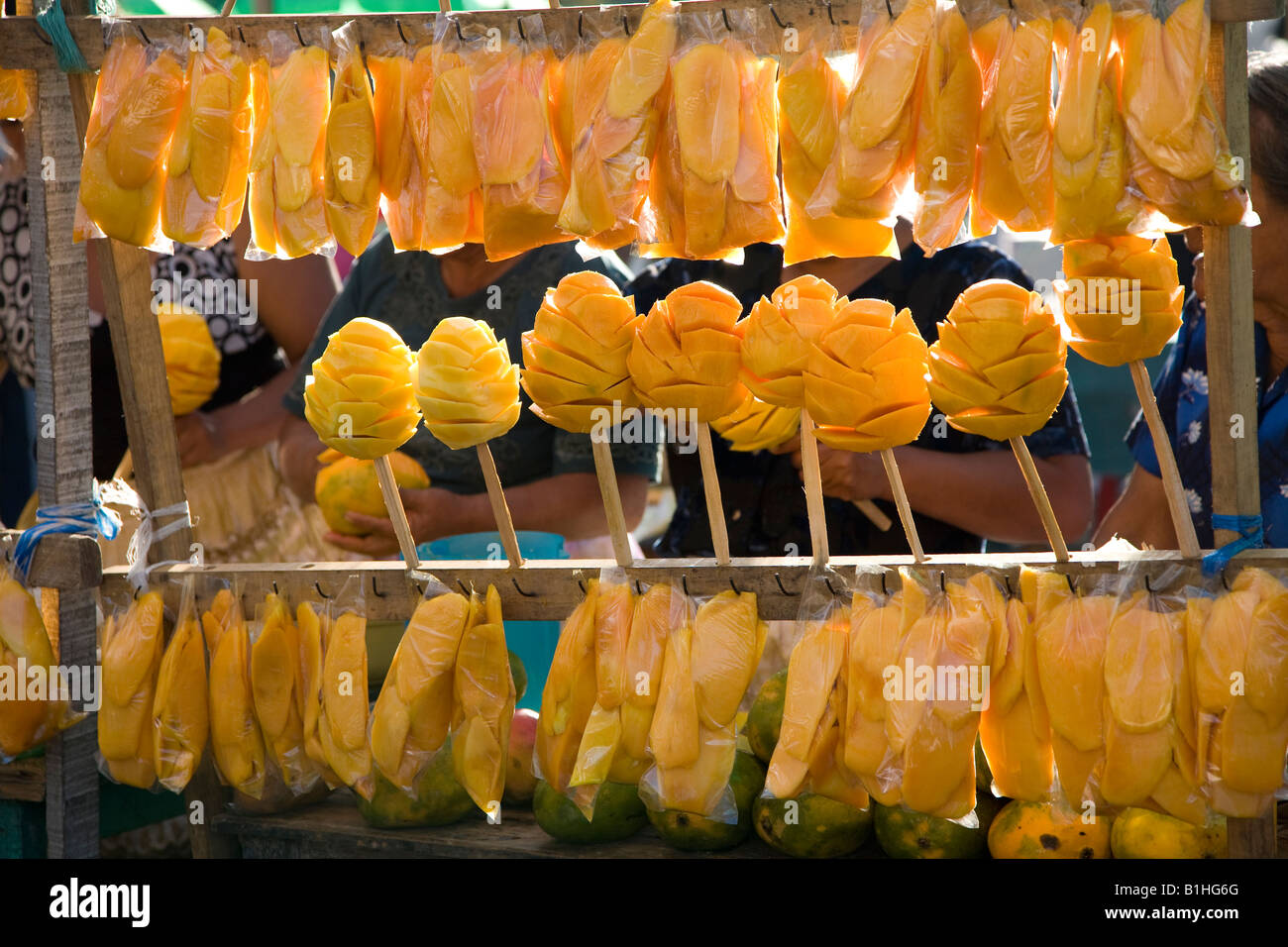 Cut up mango is sold as lollies and in bags at a stall in Antigua ...