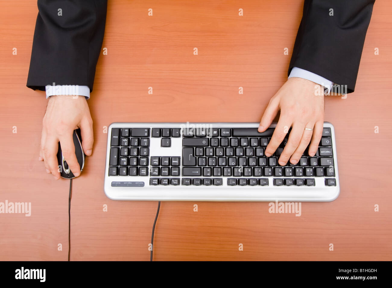 Man typing in the computer keyboard and using a mouse Stock Photo - Alamy