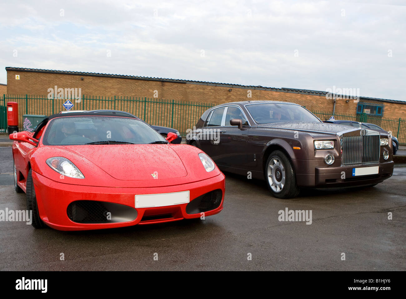 Red Ferrari F430 and Rolls Royce Stock Photo - Alamy