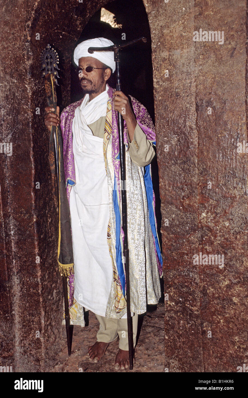 An Ethiopian orthodox priest in the enterance to one of the rock carved ...