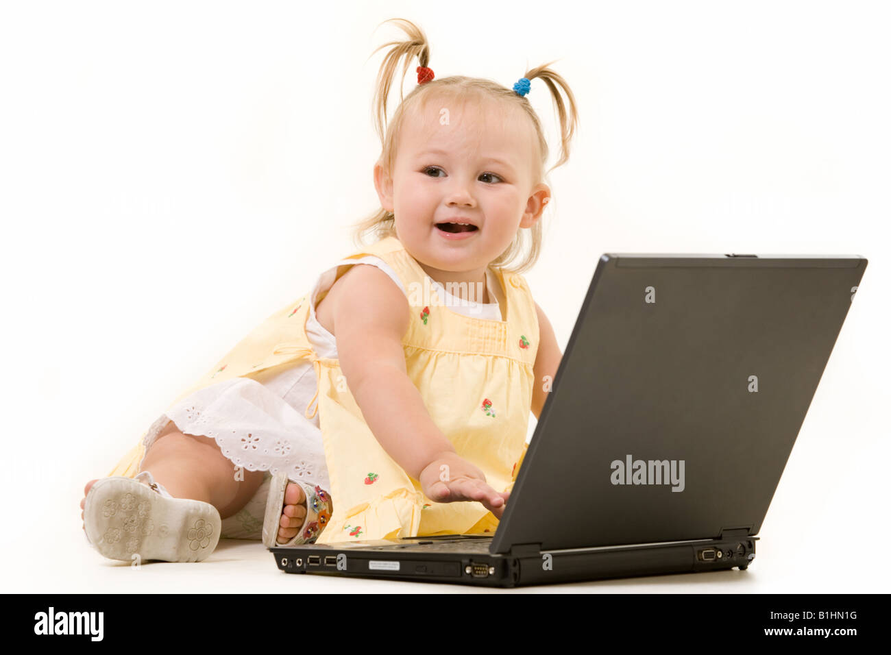 Baby on laptop Stock Photo - Alamy