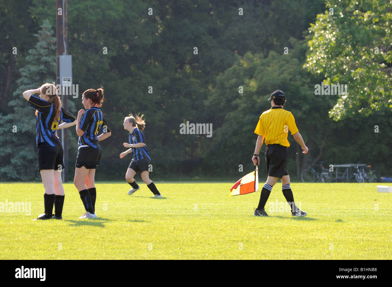 Soccer players and referee Stock Photo - Alamy