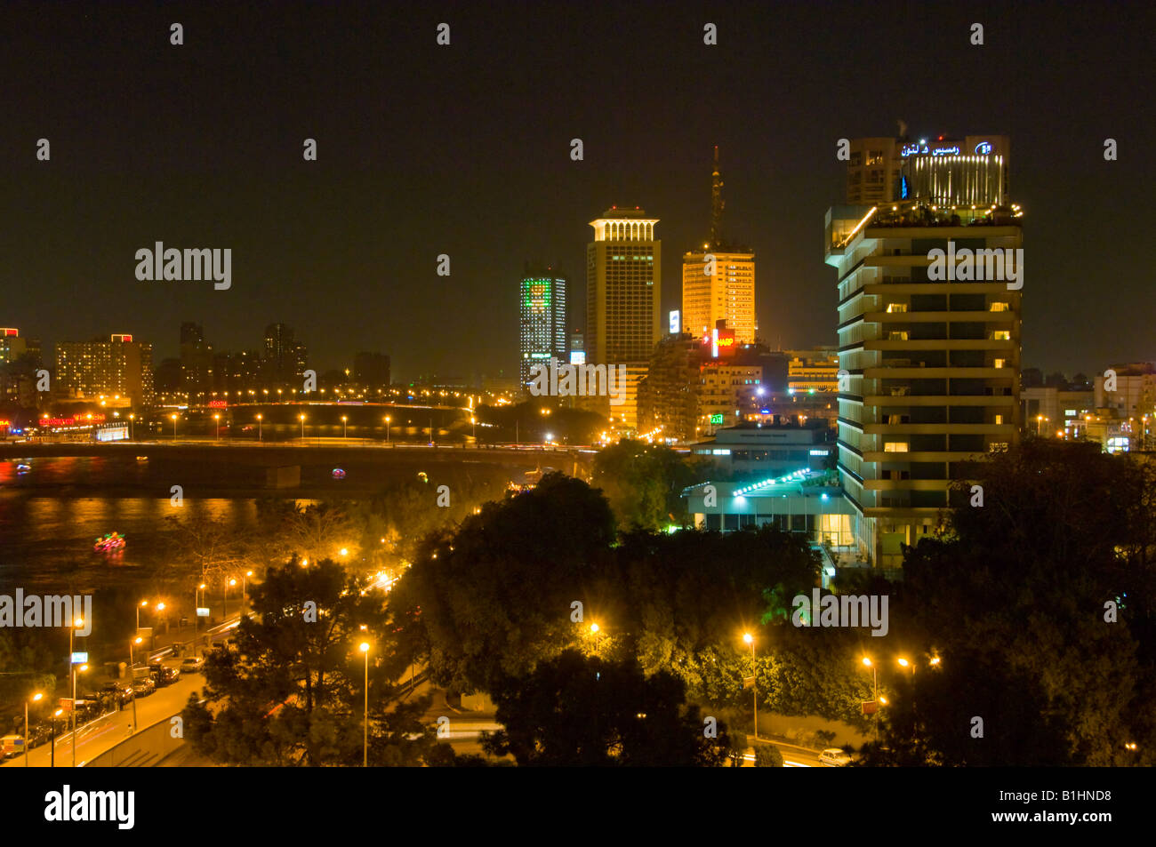 The Cairo, Egypt skyline with high rise buildings illuminated at dusk ...