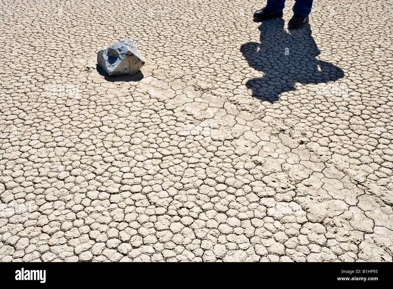 A sliding rock and man on The Racetrack Playa in a remote part of Death ...
