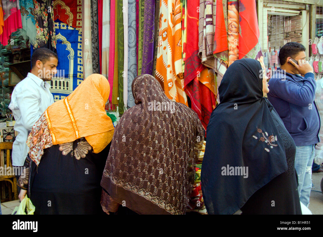 Customers buying cloth and textiles at the Khan El Khalili market in ...