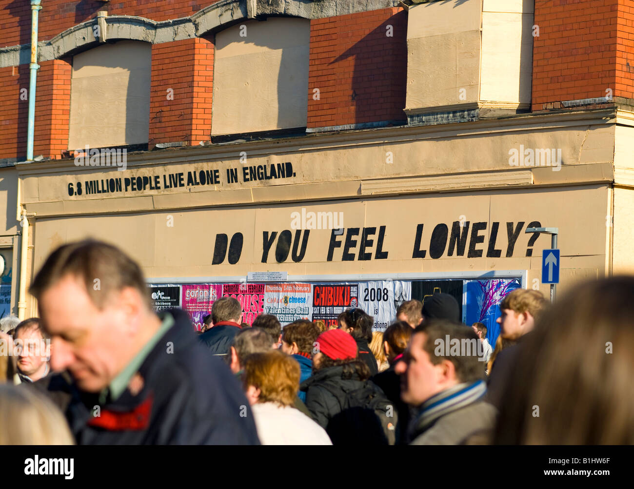 Crowds of people next to sign saying " Do you feel lonely Stock Photo ...