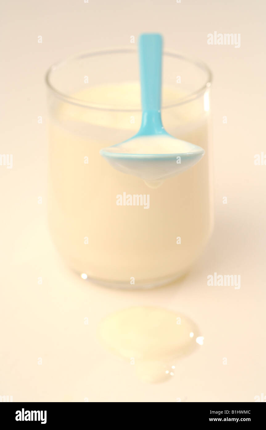 Yoghurt in a glass and a spoon Stock Photo - Alamy