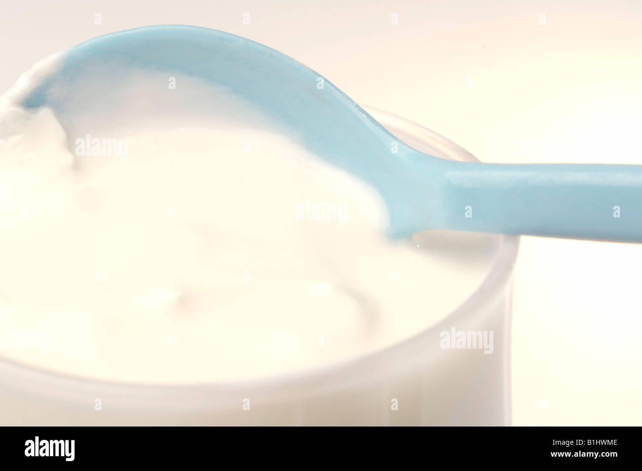 Yoghurt in a glass and a spoon Stock Photo - Alamy