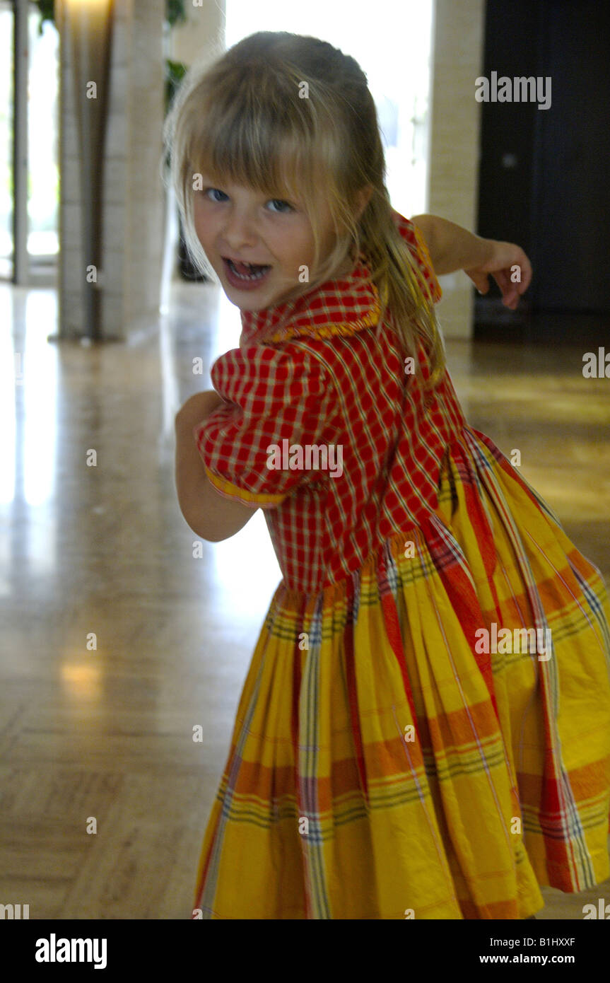 Little girl in a yellow and red checked dress Stock Photo - Alamy