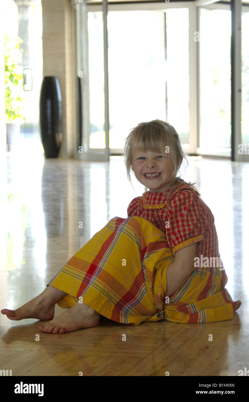 Little girl in a yellow and red checked dress Stock Photo - Alamy