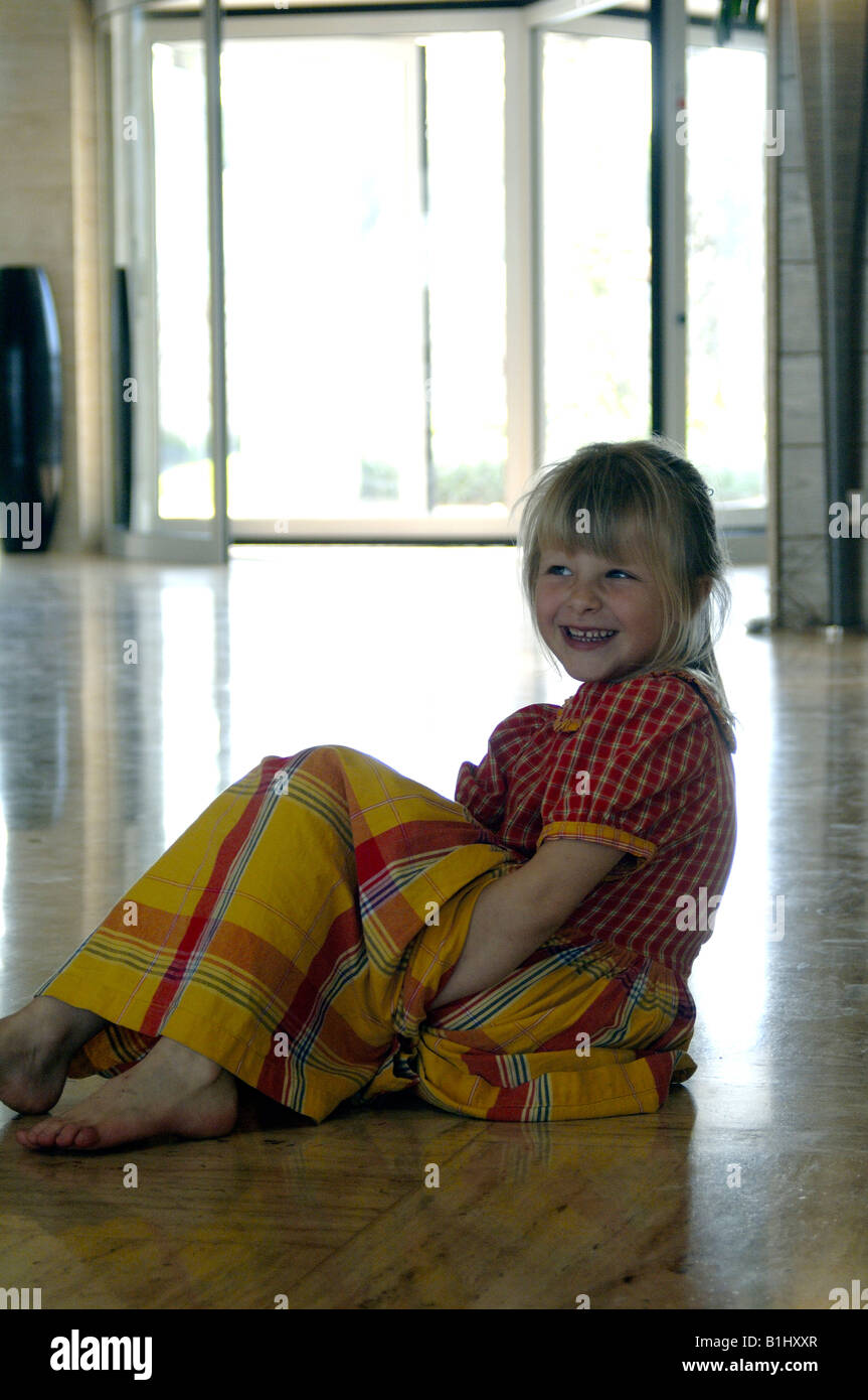 Little girl in a yellow and red checked dress Stock Photo - Alamy