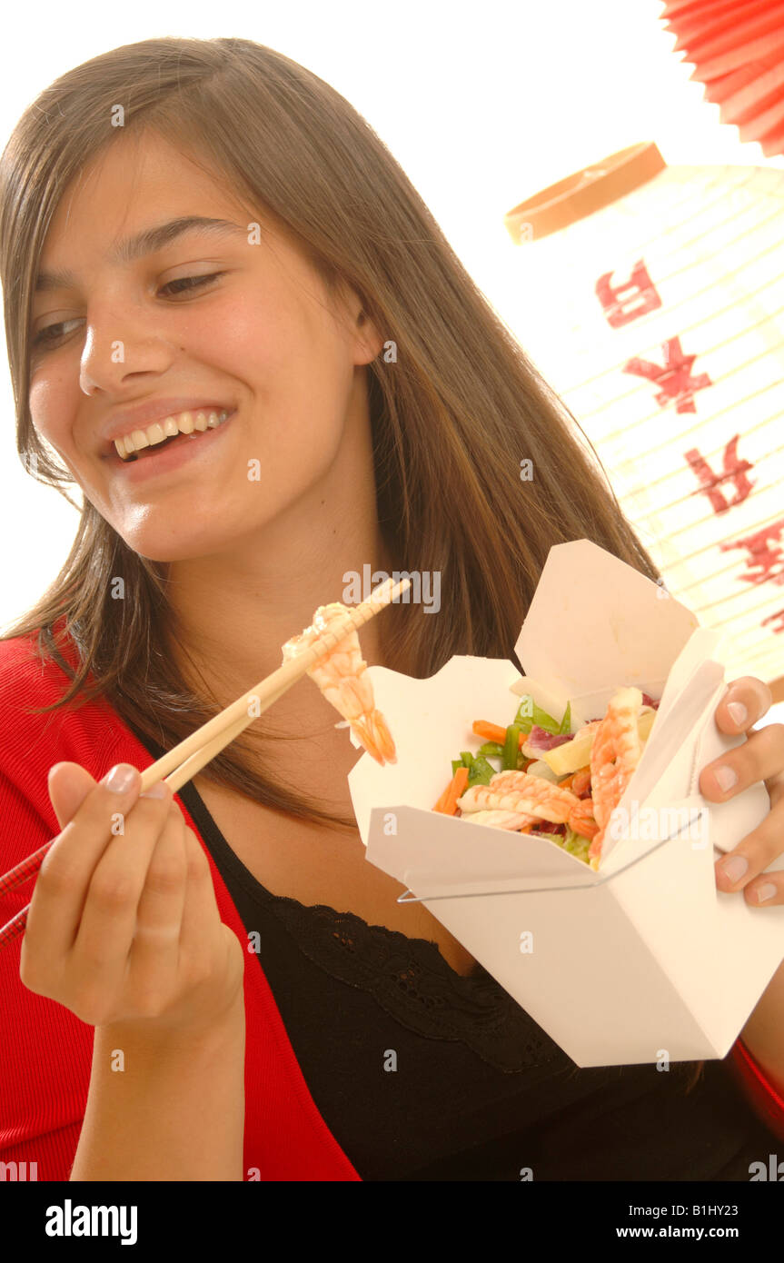 Woman is eating Asian food with chopsticks Stock Photo - Alamy