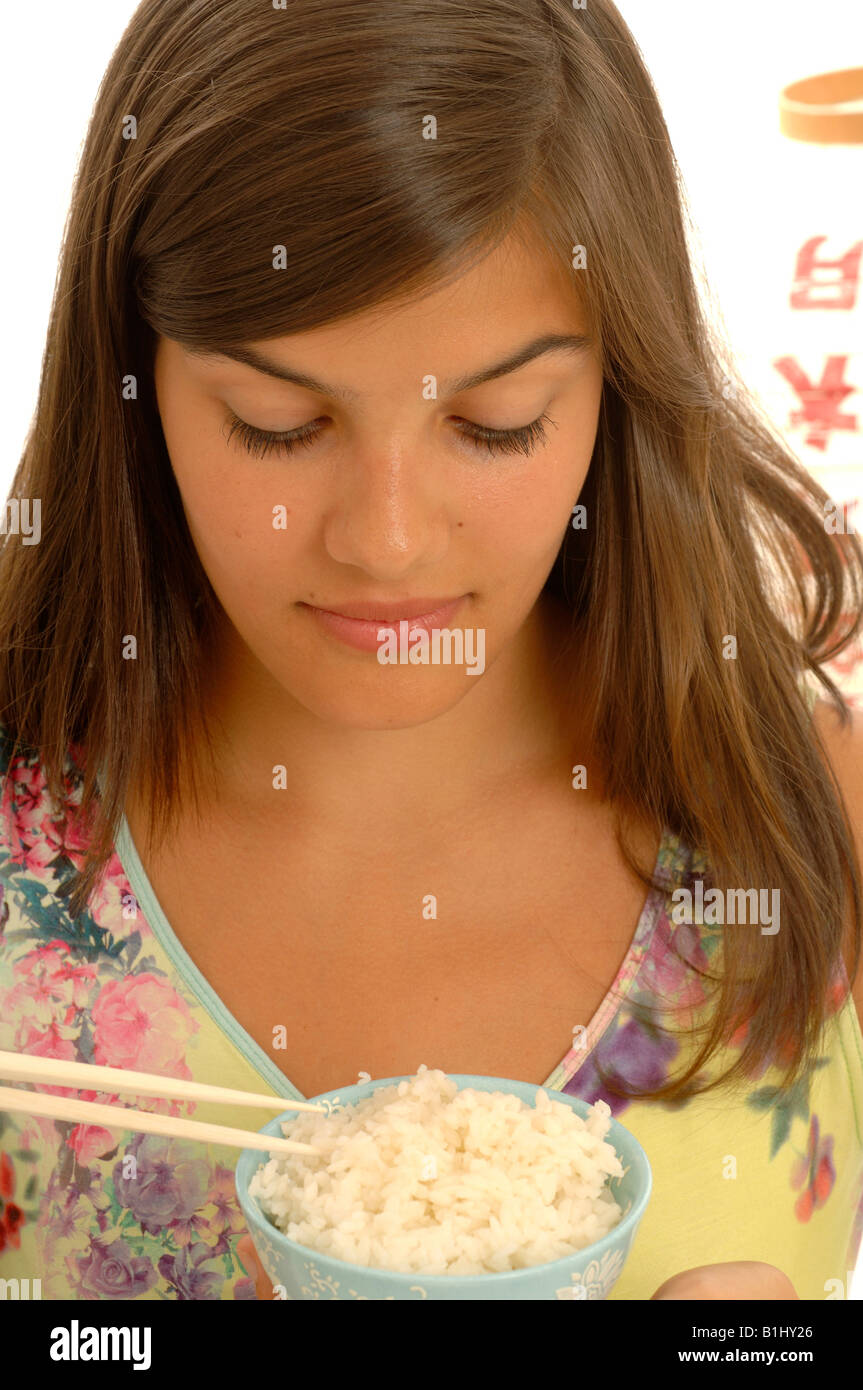 Woman is eating rice with chopsticks Stock Photo - Alamy