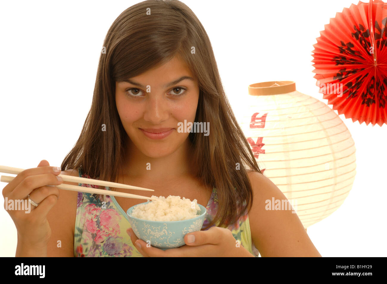 Woman is eating rice with chopsticks Stock Photo - Alamy