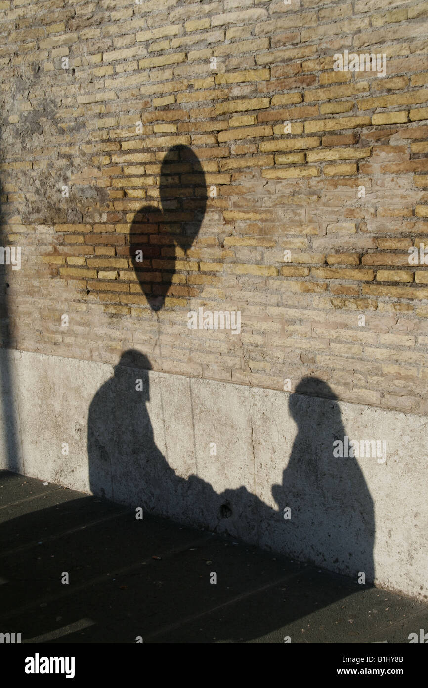couple and balloon shadow against wall Stock Photo - Alamy
