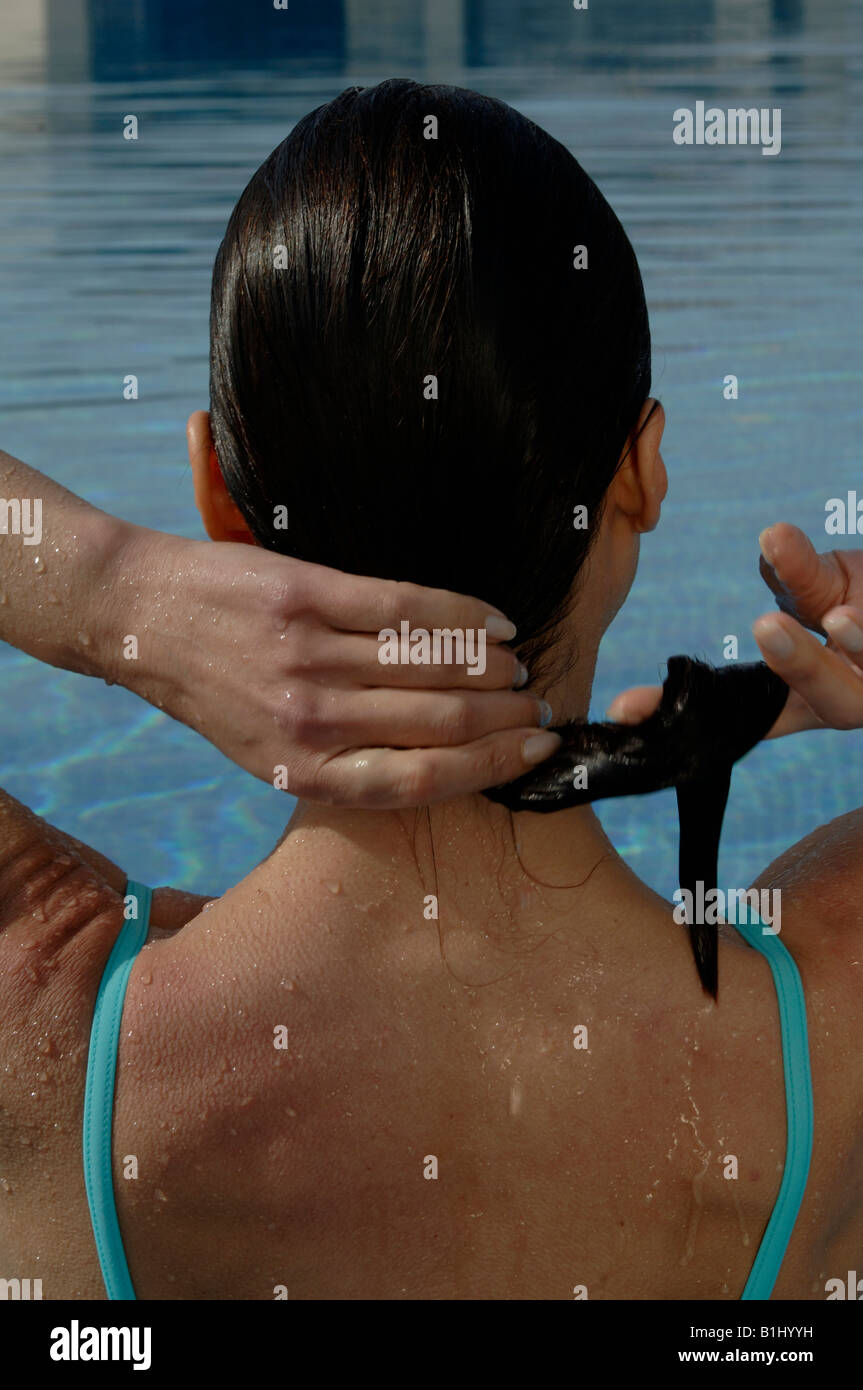 Woman in the swimming pool - back view Stock Photo - Alamy