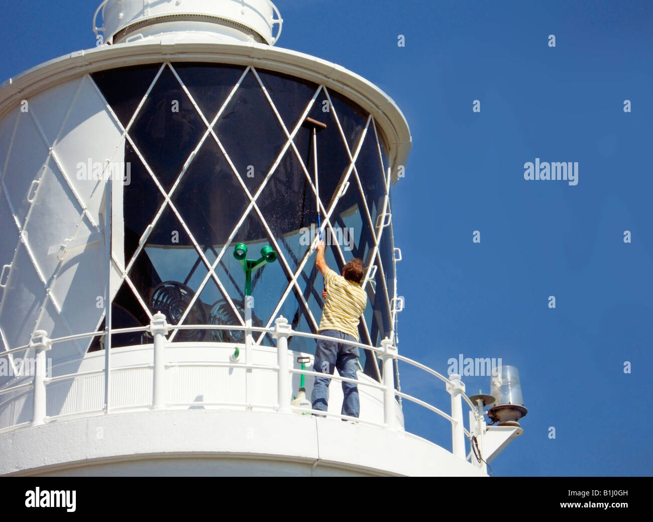 Window cleaner, cleaning the glass windows of Lowestoft Lighthouse ...