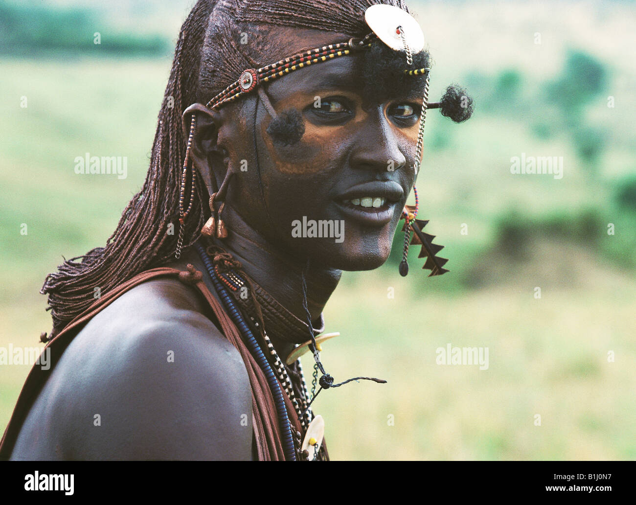 Portrait of Maasai moran or warrior wearing red ochre make up and ...