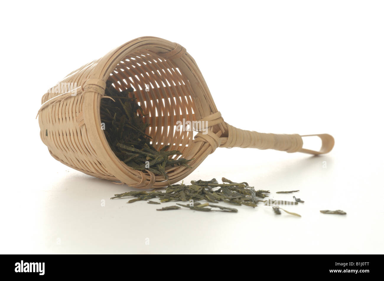 Bamboo tea strainer and green tea Stock Photo - Alamy