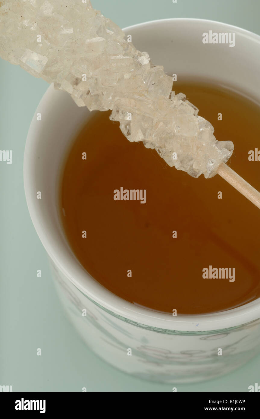 Tea cup with rock candy Stock Photo - Alamy