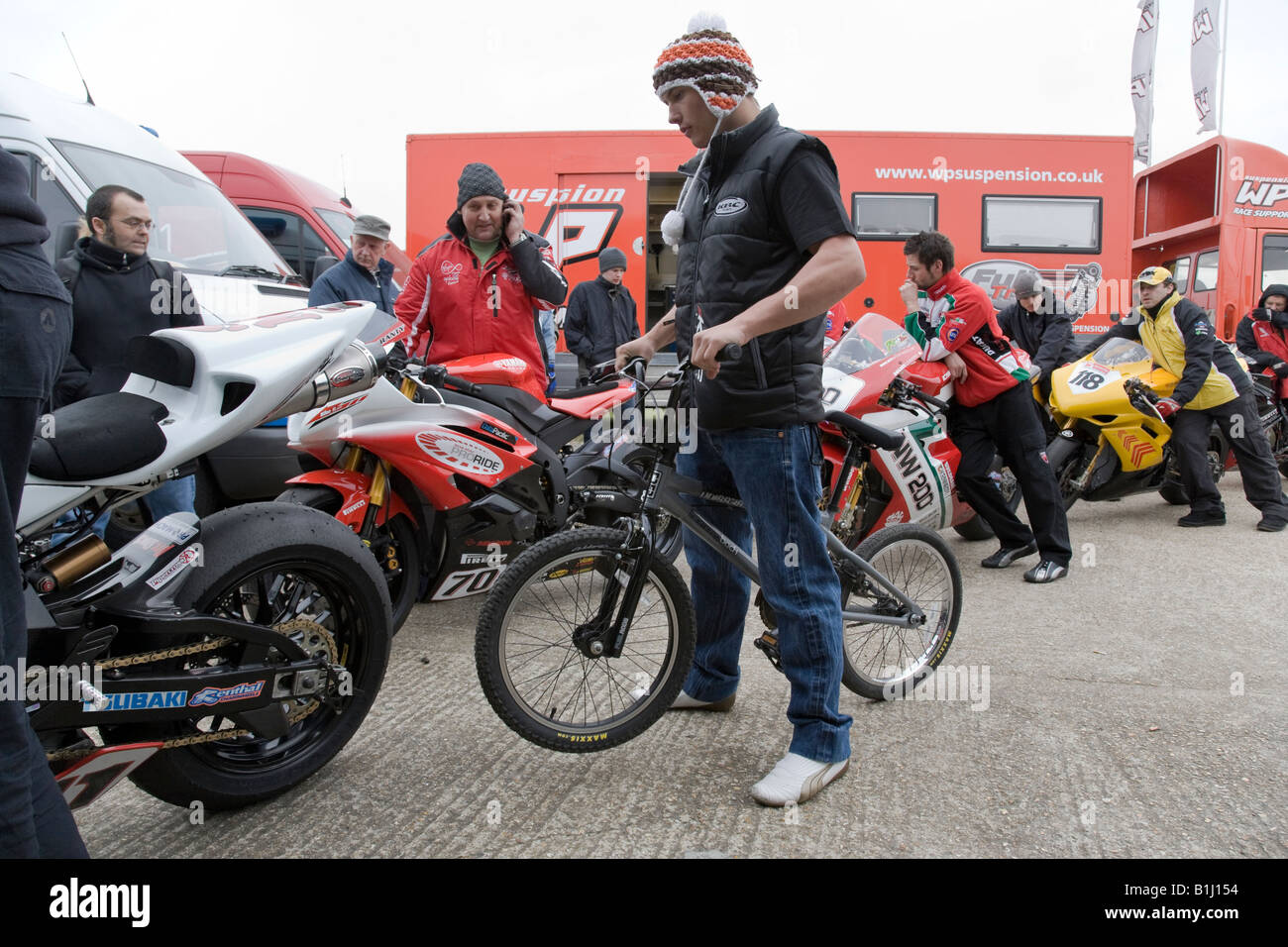 Racing motorcycles queue to pass through scrutineering during practice ...