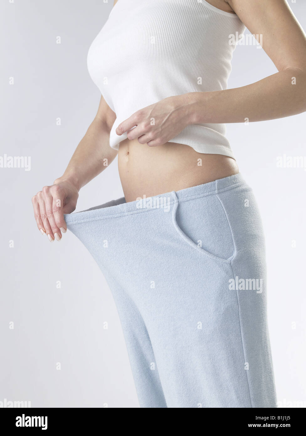 Woman is checking her weight Stock Photo - Alamy