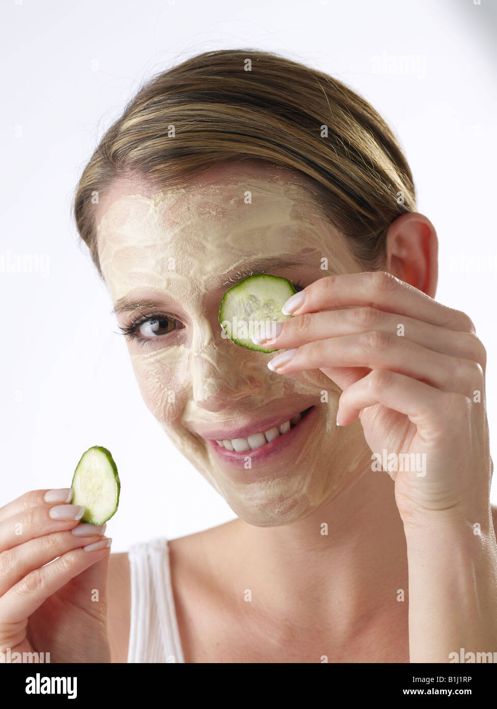 Woman with a cucumber mask Stock Photo - Alamy
