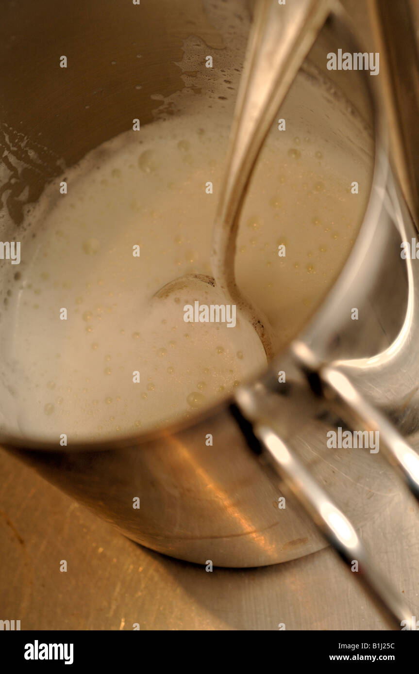 Pot filled with milk froth Stock Photo - Alamy