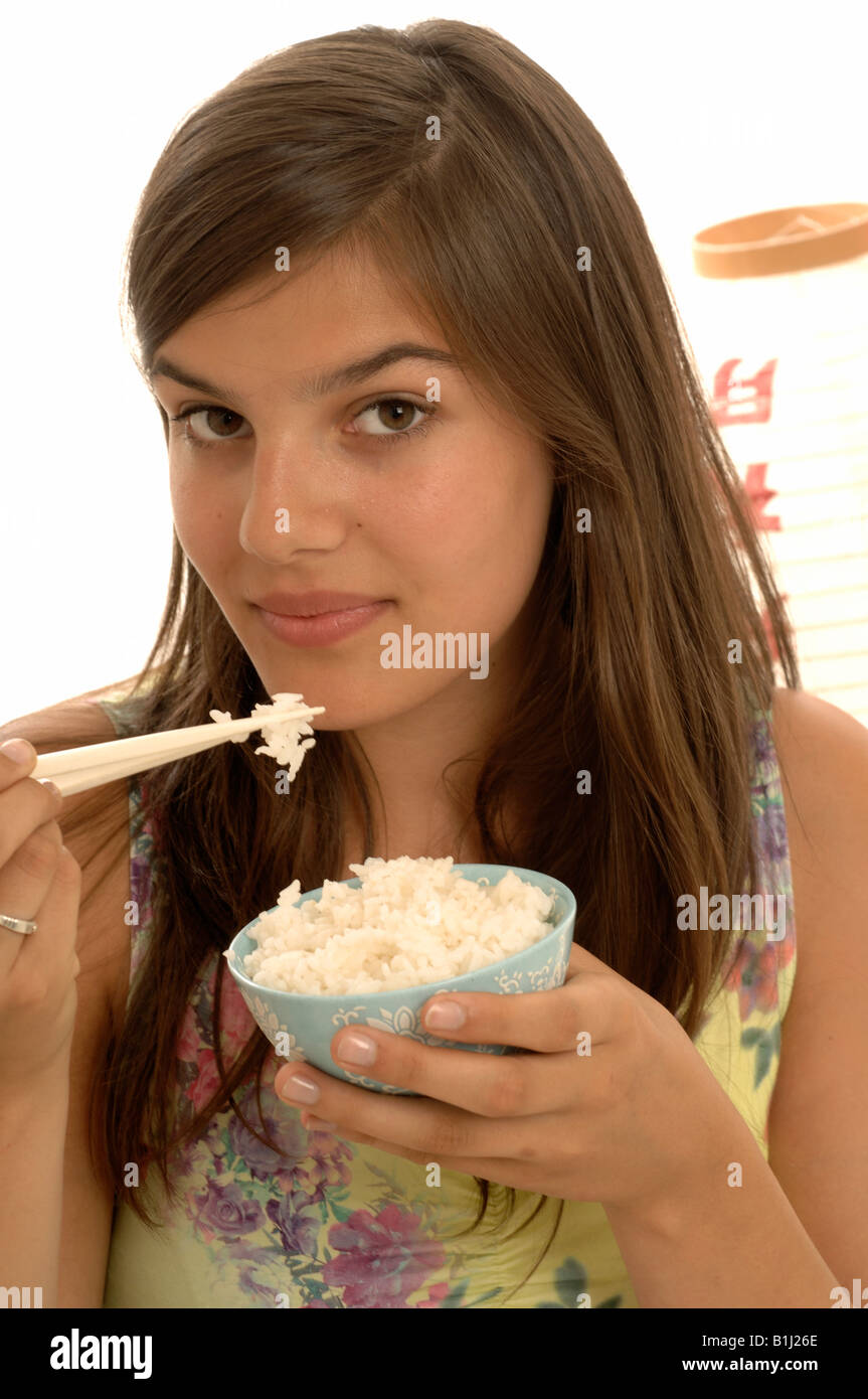 Woman eating rice with chopsticks Stock Photo - Alamy