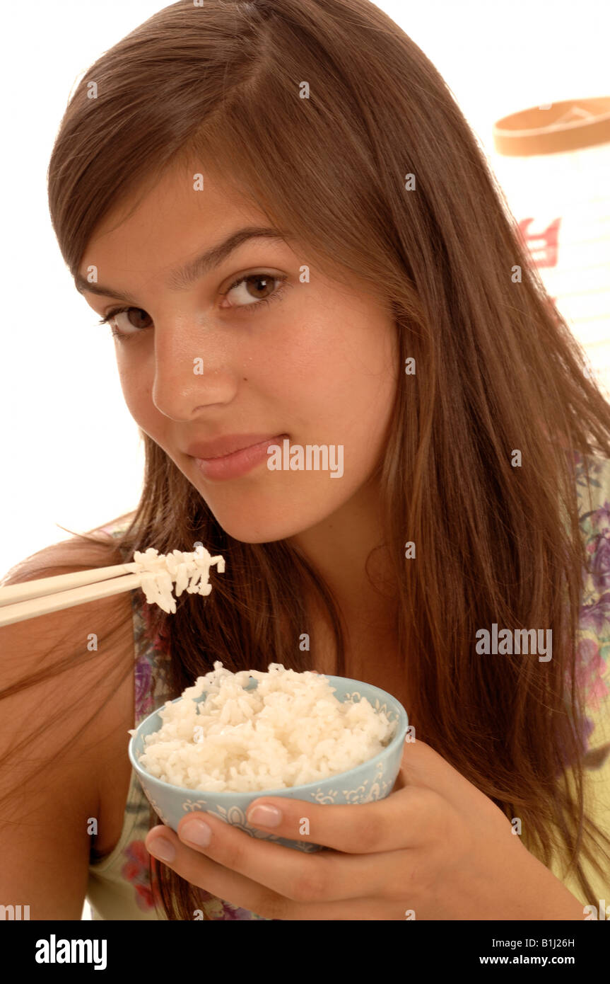 Woman eating rice with chopsticks Stock Photo - Alamy
