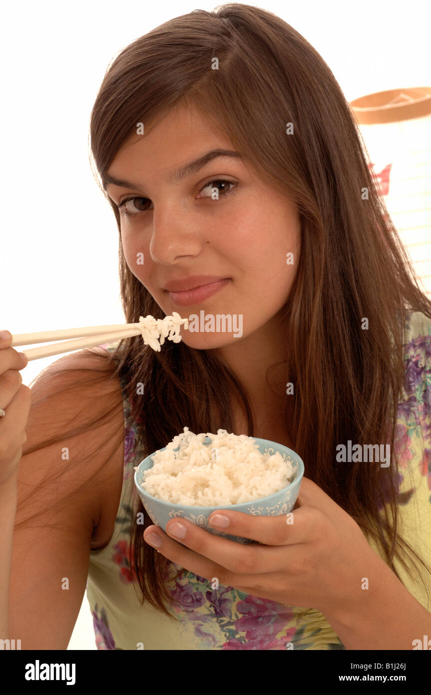 Woman eating rice with chopsticks Stock Photo - Alamy