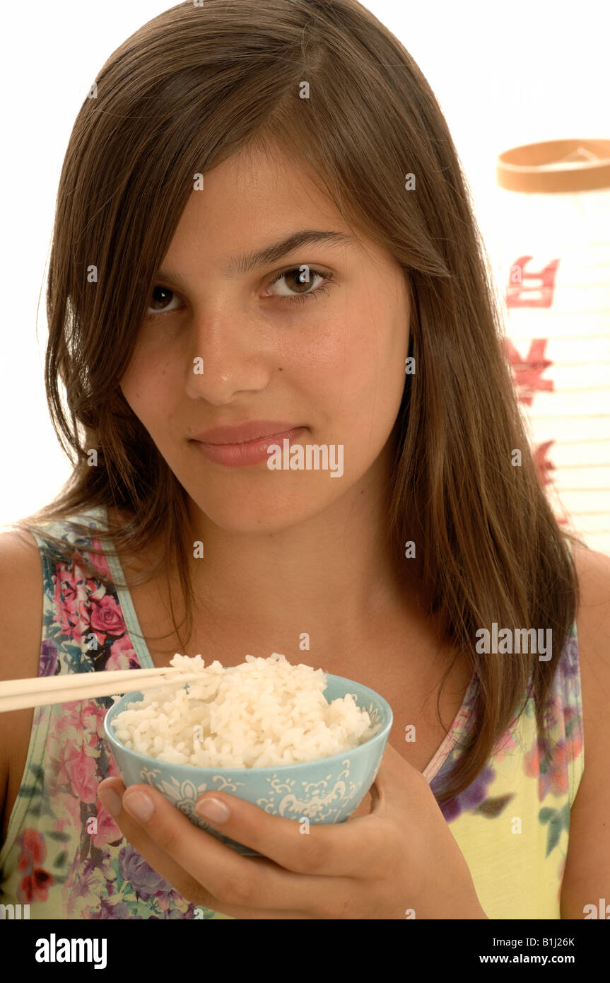 Woman eating rice with chopsticks Stock Photo - Alamy