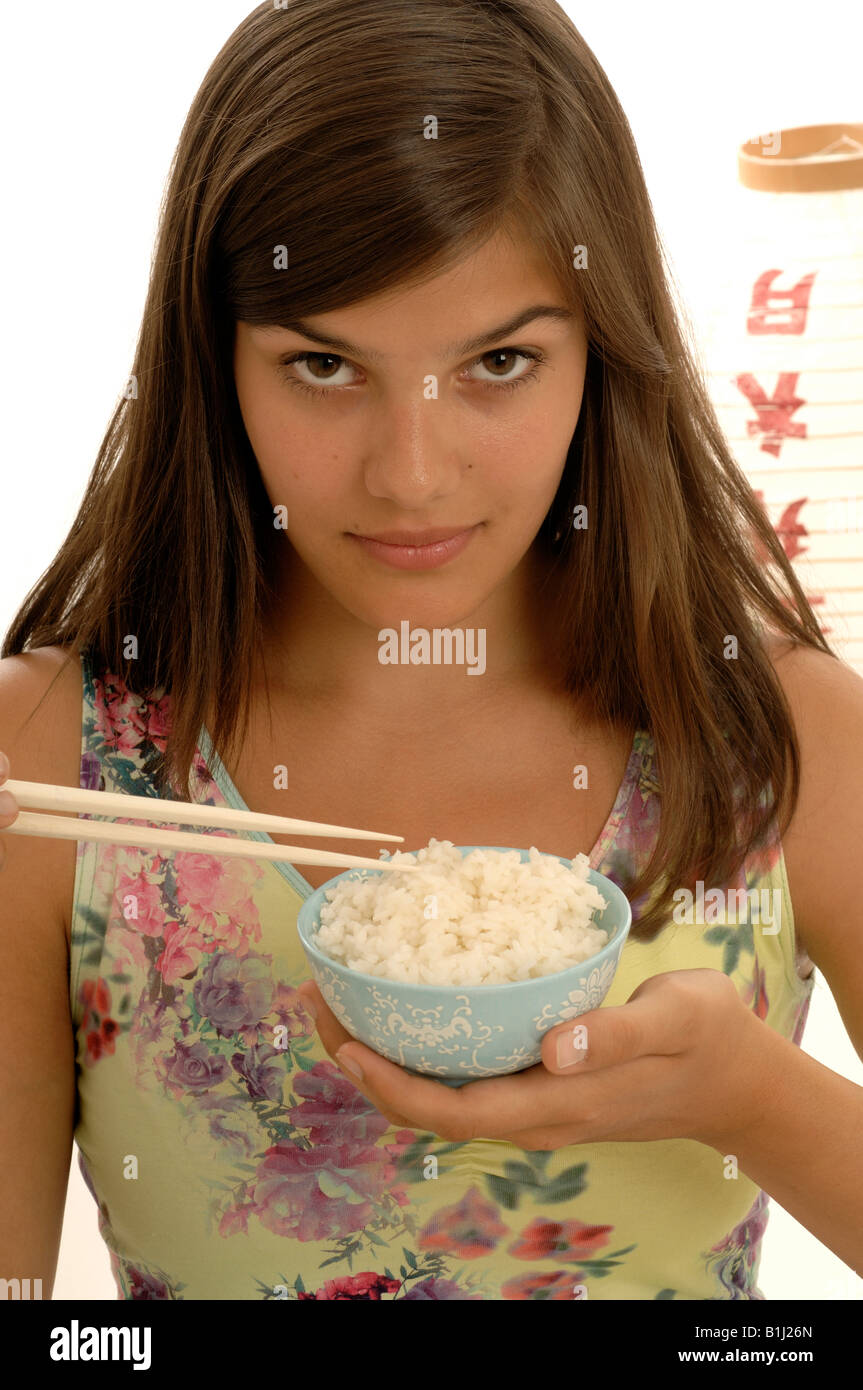 Woman eating rice with chopsticks Stock Photo - Alamy