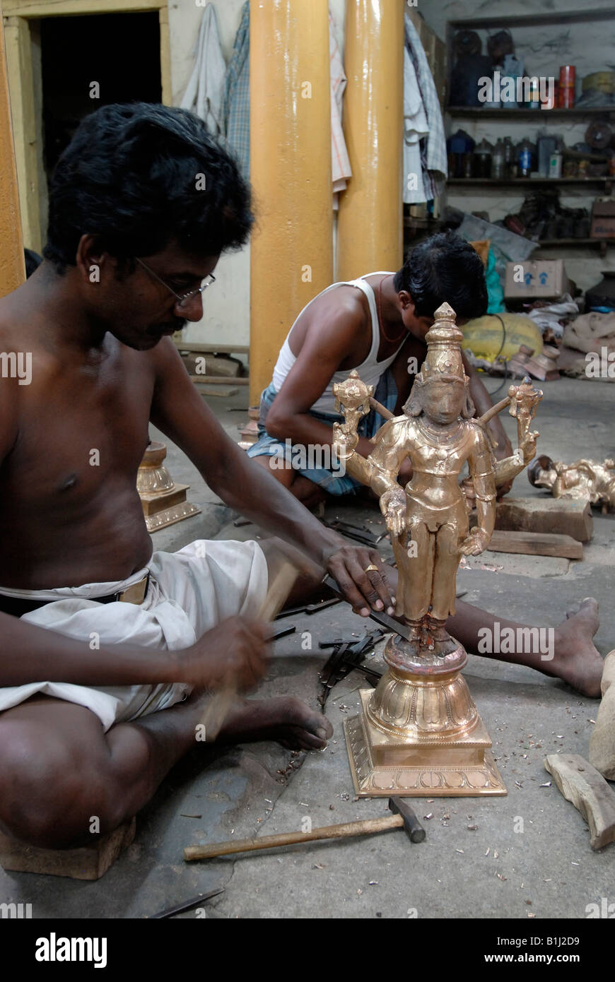 Sculptors making a bronze sculpture of a Hindu god, Swamimalai ...
