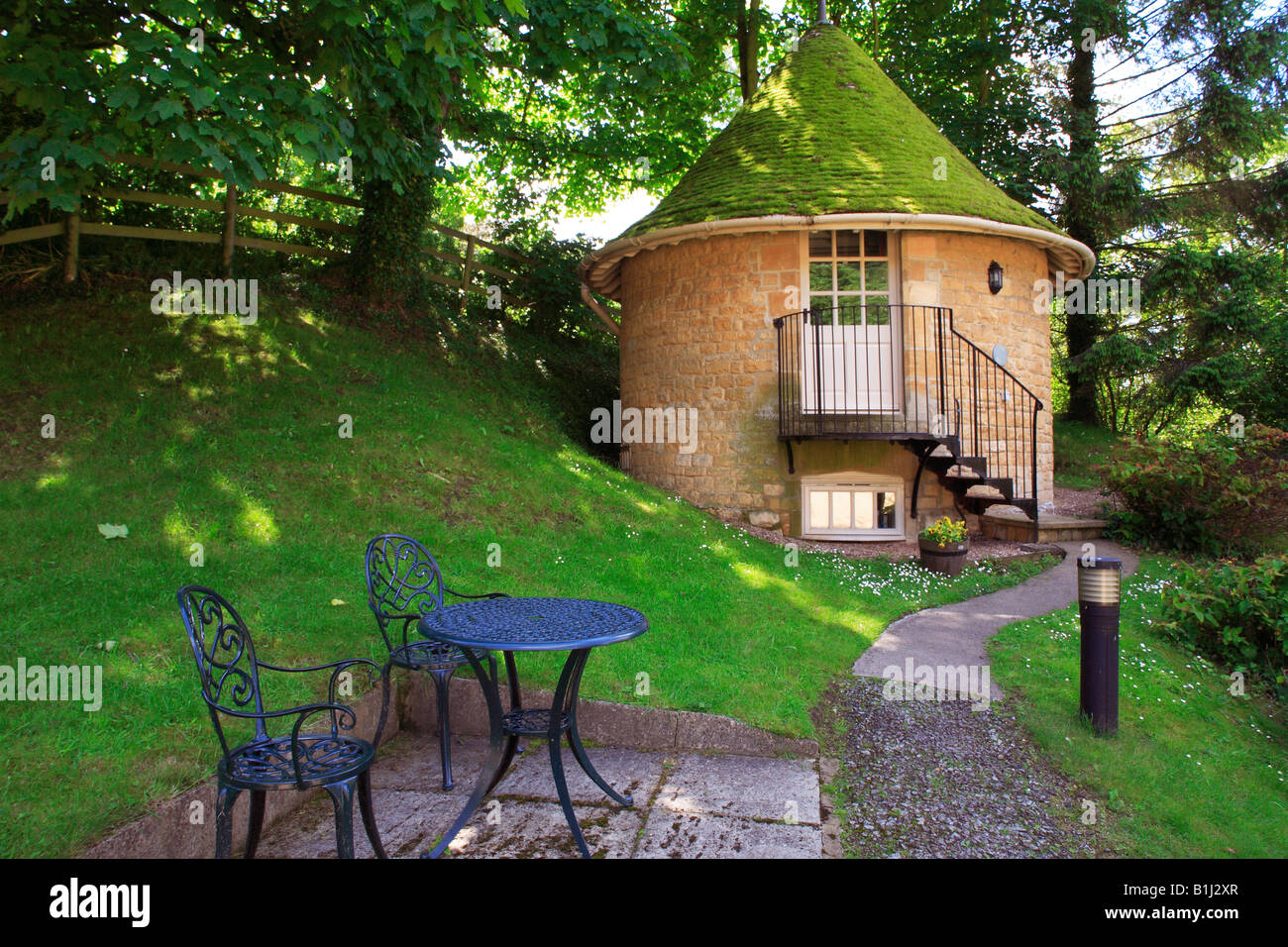 Round stone cottage in Buckland The Cotswolds England Stock Photo - Alamy