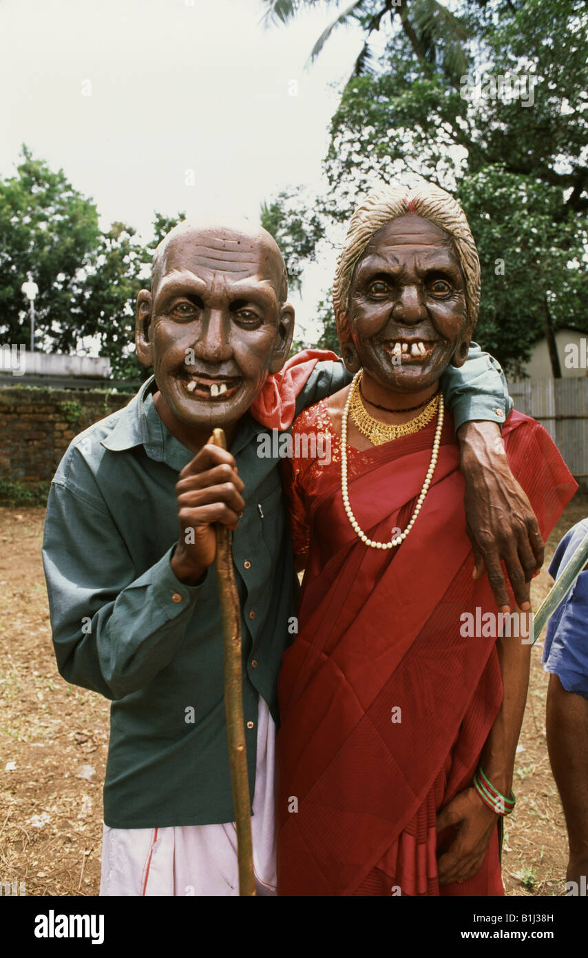Male and a female Kummatti Kali dancers standing with arm around ...