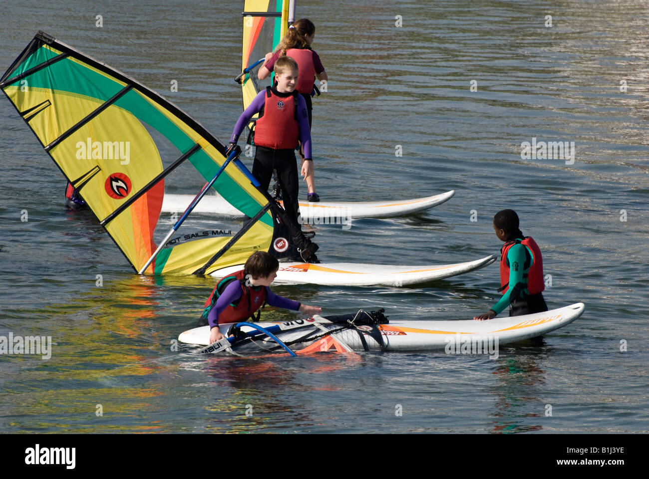 Group Children learning wind surfing Stock Photo - Alamy