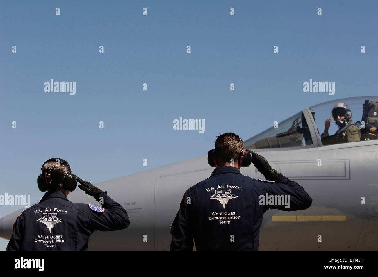 US Air Force Senior Airmen salute the Captain in an F-15 Eagle during a ...
