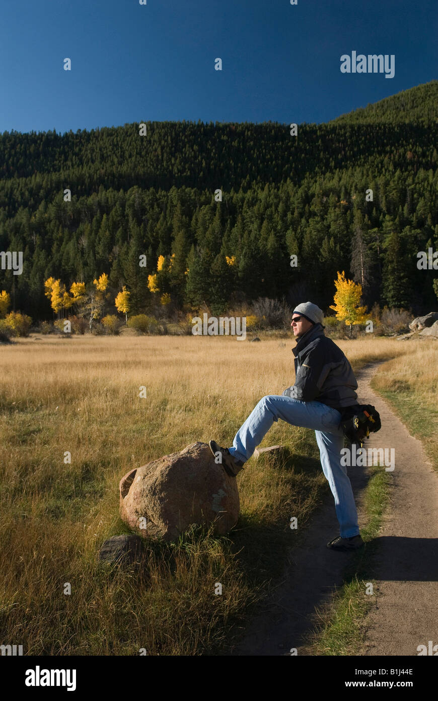 Hiker standing in a field, Rocky Mountain National Park, Colorado, USA ...
