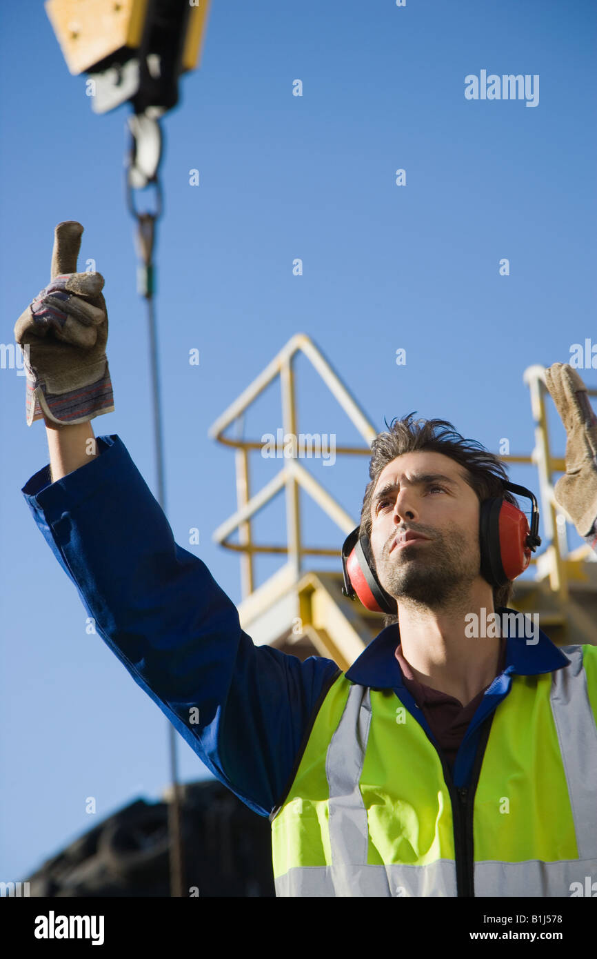 A harbour worker pointing Stock Photo - Alamy