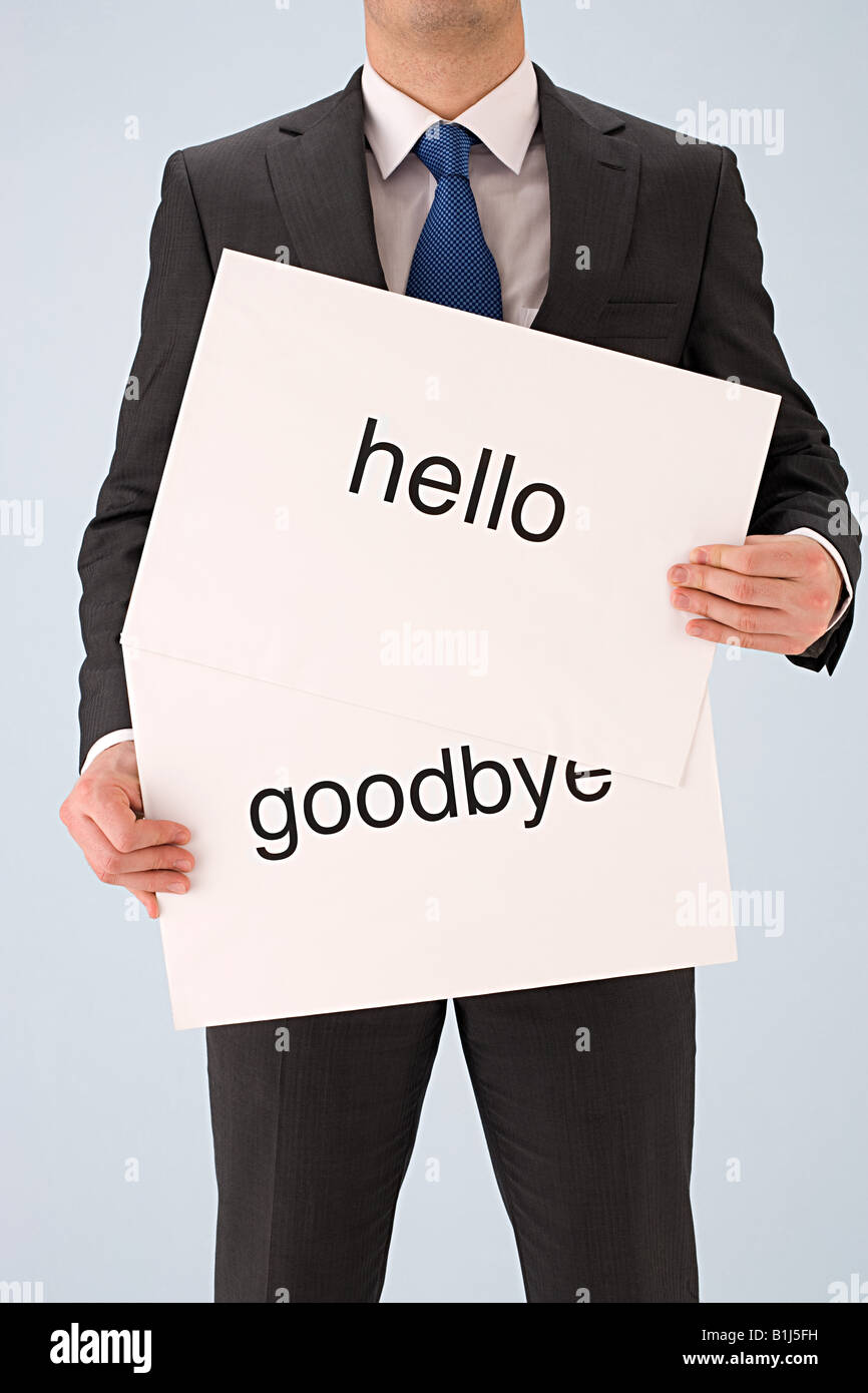 Businessman holding greeting signs Stock Photo - Alamy