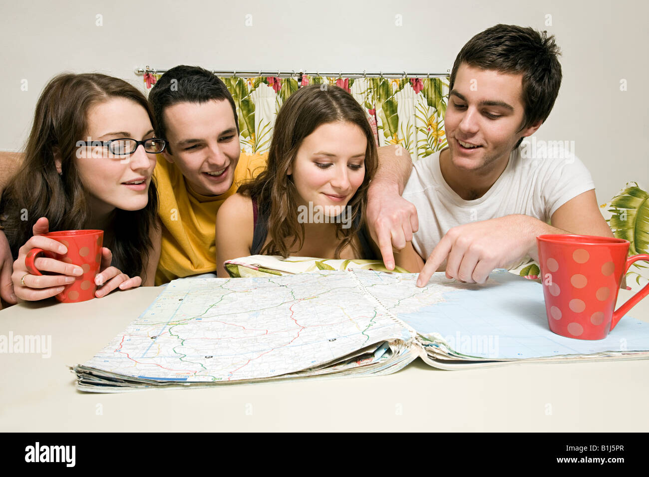 Friends looking at a map Stock Photo - Alamy