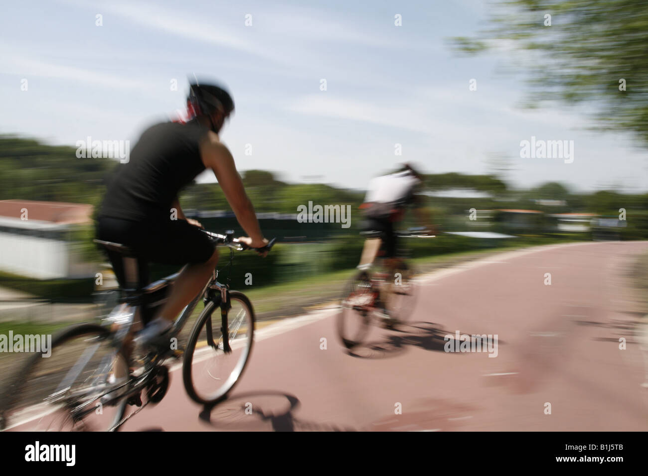 two fast bike riders in countryside Stock Photo - Alamy