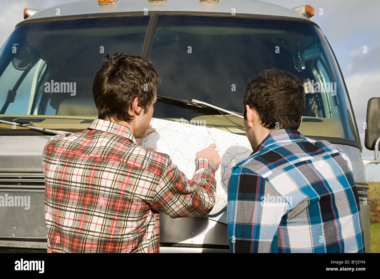 Teenage boys looking at a map Stock Photo - Alamy